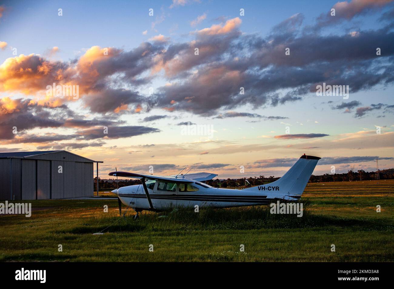 A two seater plane at the countryside airport during golden hour Stock ...