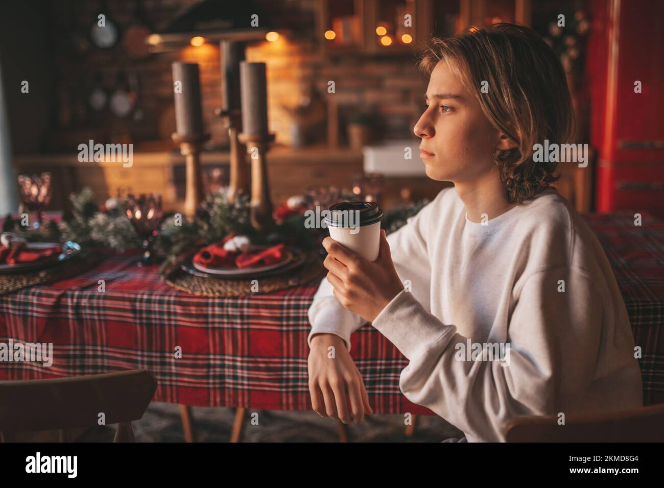 Young teen boy with long hair thoughtful look sad eyes negative mood ...