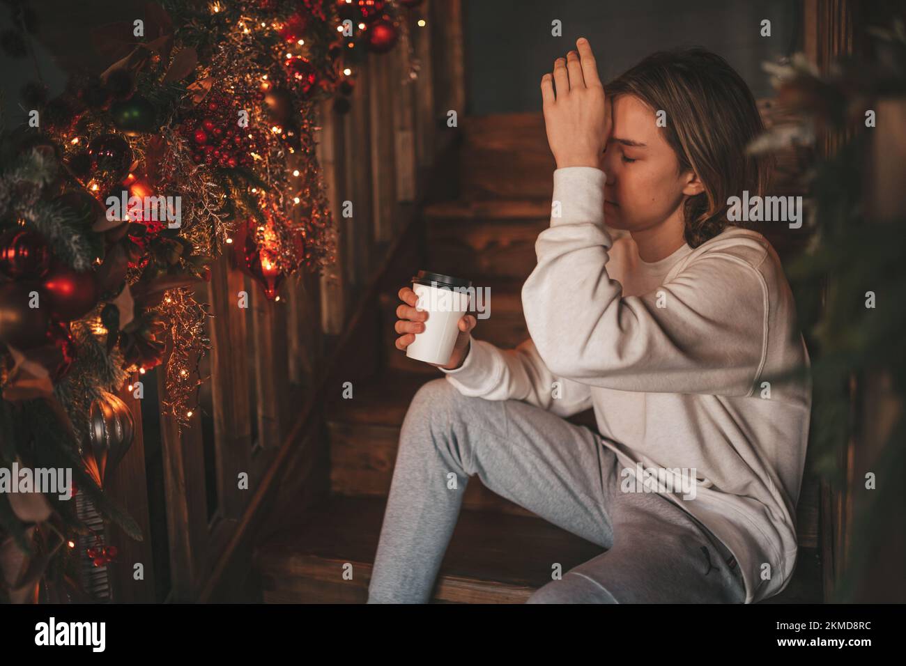 Young teen boy with long hair thoughtful look sad eyes negative mood ...