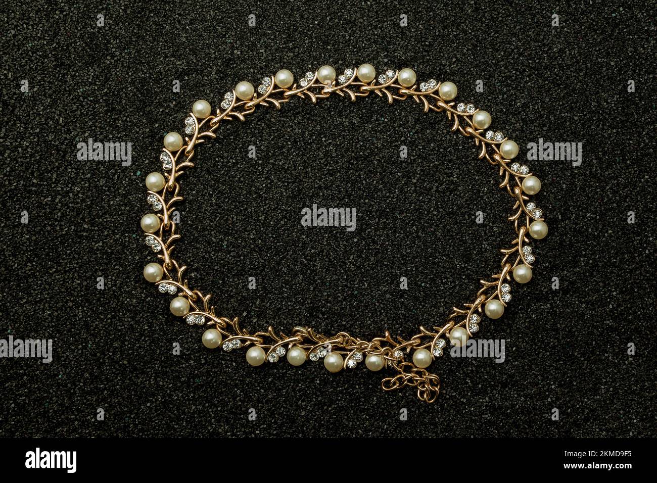 Photo of golden set with gems over dark background Stock Photo - Alamy