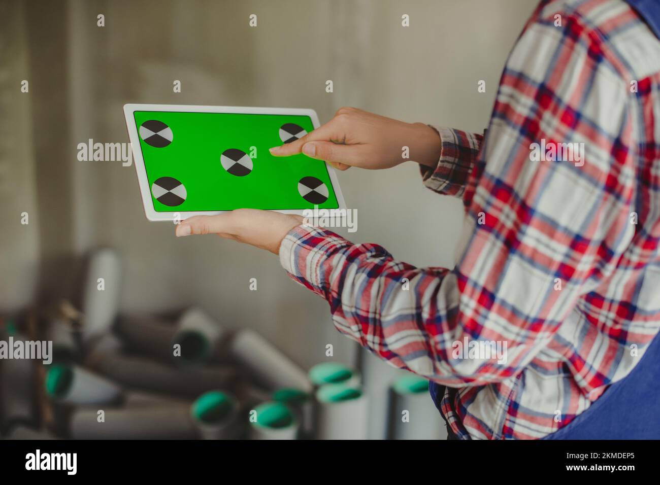 woman construction manager using tablet device with green screen and ...