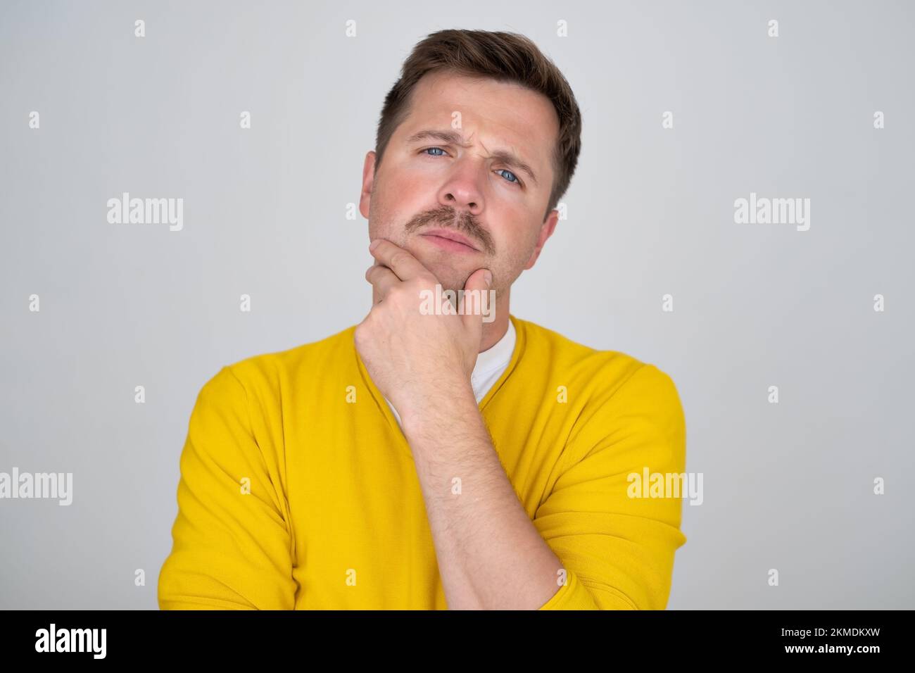 Thoughtful caucasian young man touch chin with finger thinking Stock ...