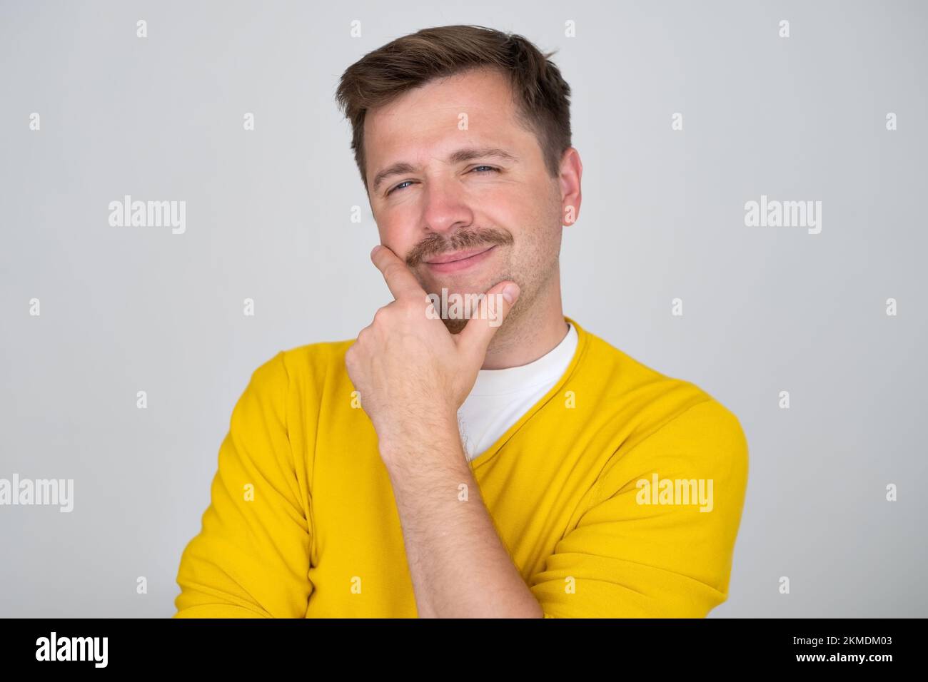 Thoughtful caucasian young man touch chin with finger thinking Stock ...