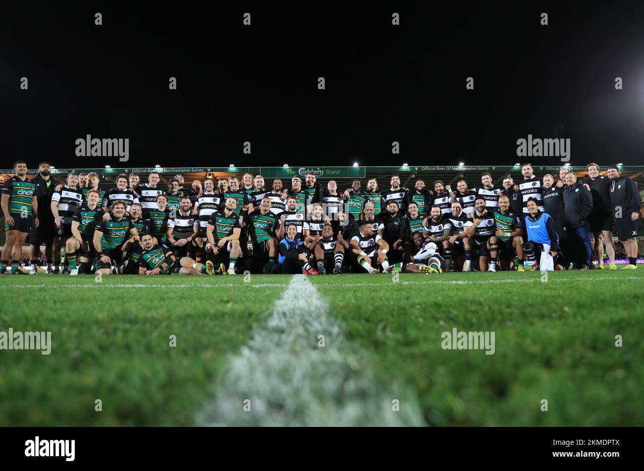 The players of both teams pose for a photo after the club friendly ...