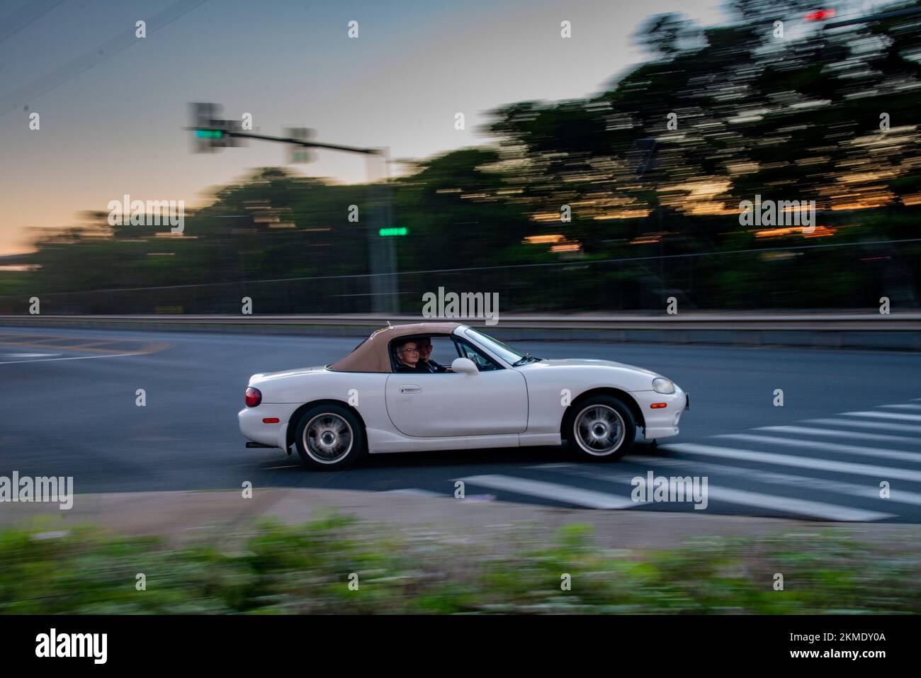Sunsel motion blur vehicle oahu, Hi sunset Stock Photo - Alamy