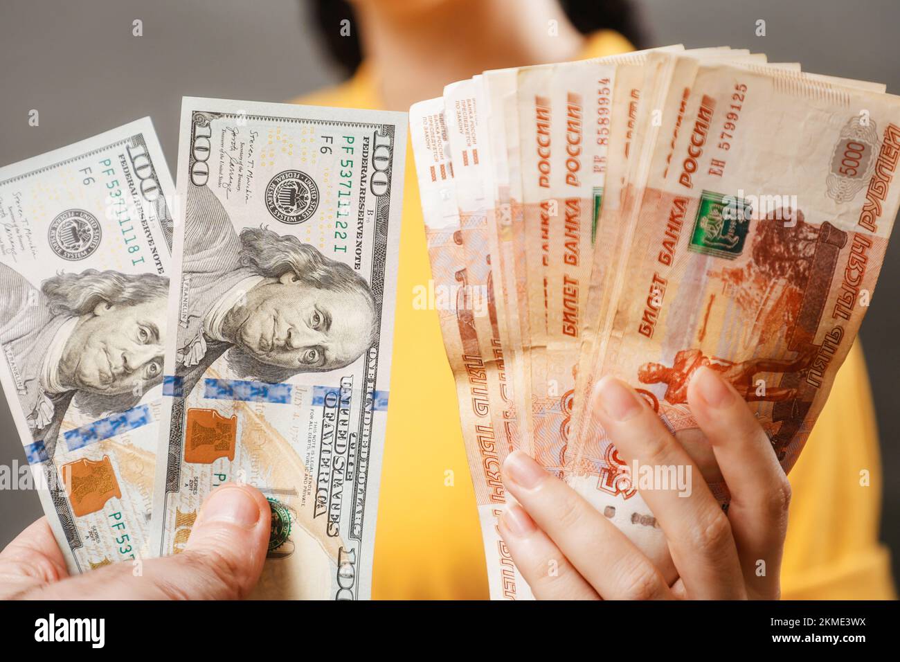 Shopping and exchange. Woman holds fans of dollar bills and rubles in ...