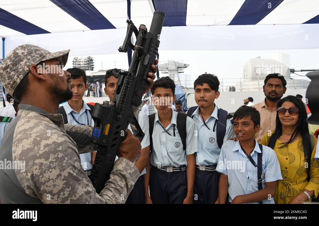 A Marine commando demonstrates working of a machine gun to school ...