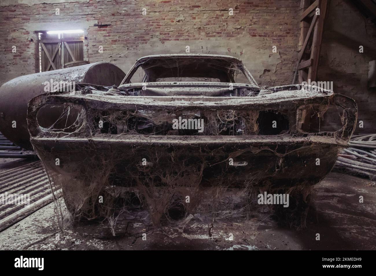 Old disassembled car in an abandoned factory Stock Photo - Alamy