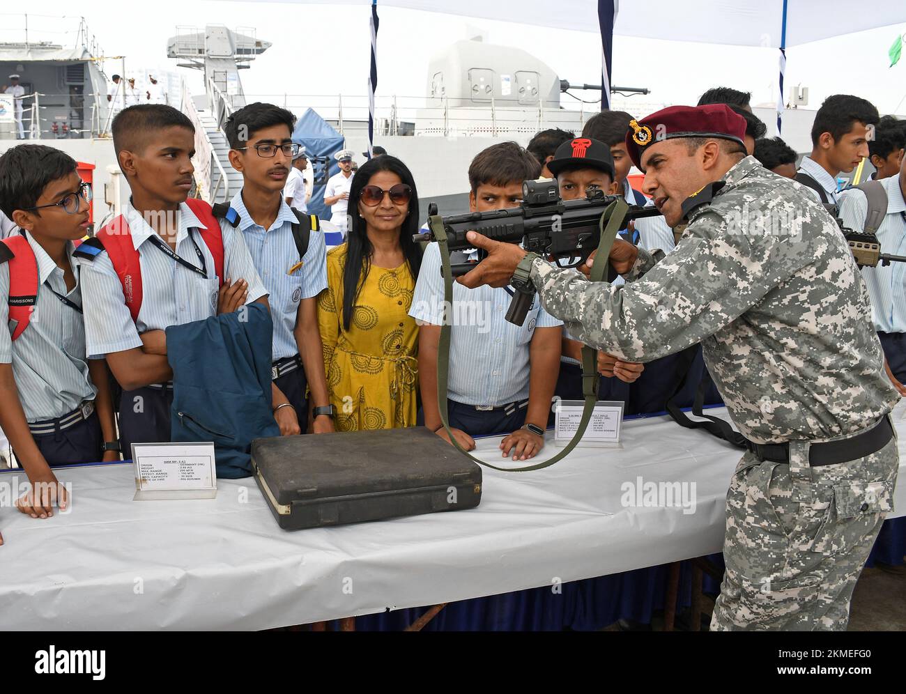 A Marine commando demonstrates working of a machine gun to school ...