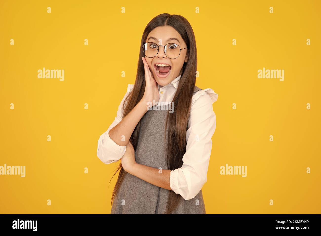 Shocked teenager child with amazed look on yellow background, amazement ...