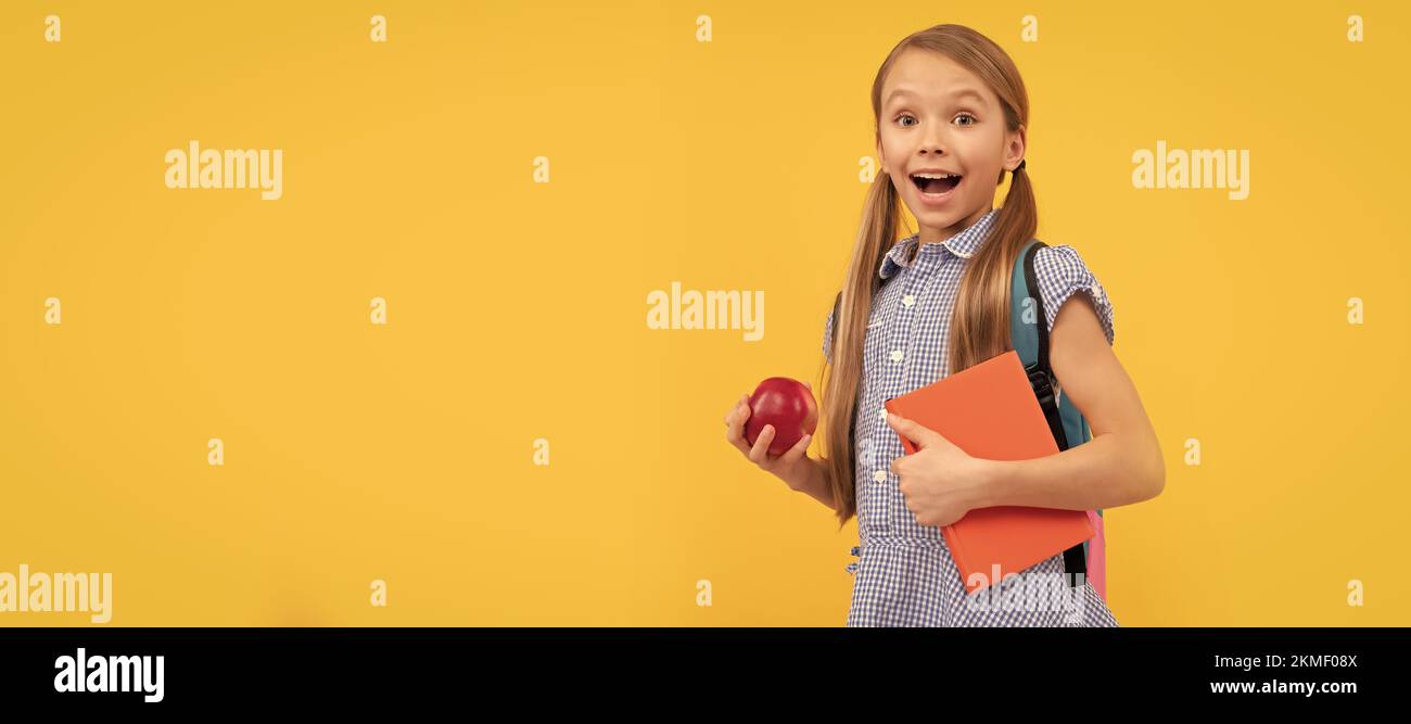 Surprised girl child hold tasty apple for healthy back to school snack ...