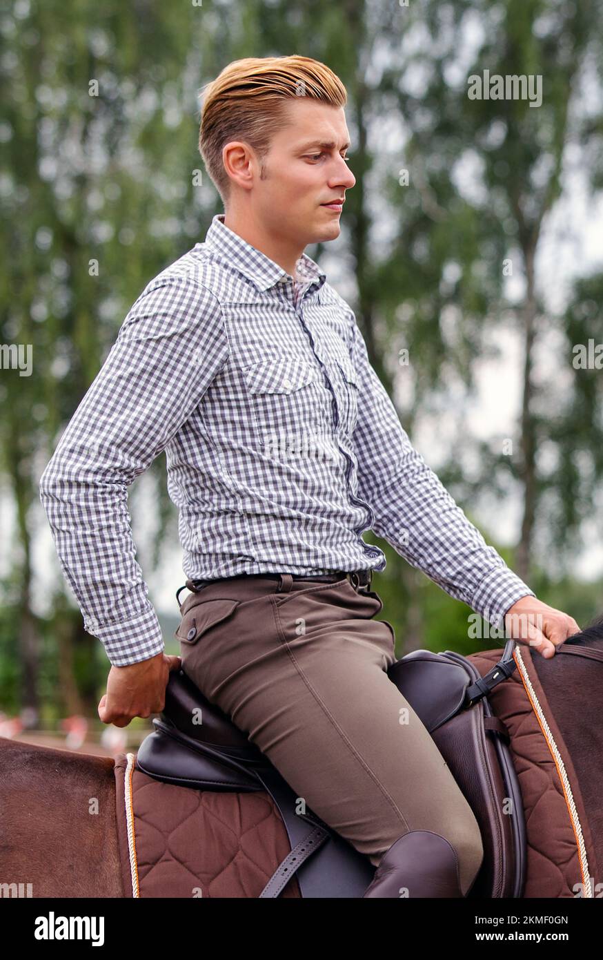 handsome young man riding brown horse on the countryside Stock Photo ...