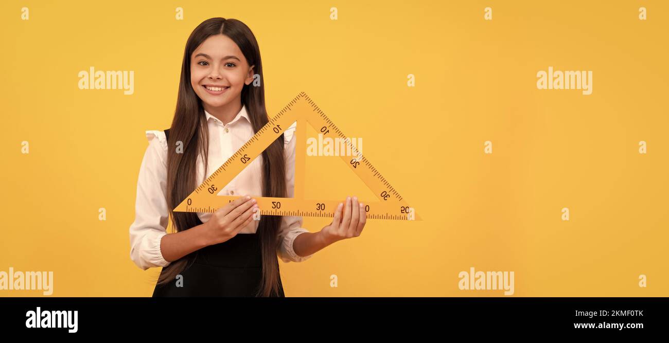 smiling kid in school uniform hold mathematics triangle for measuring ...