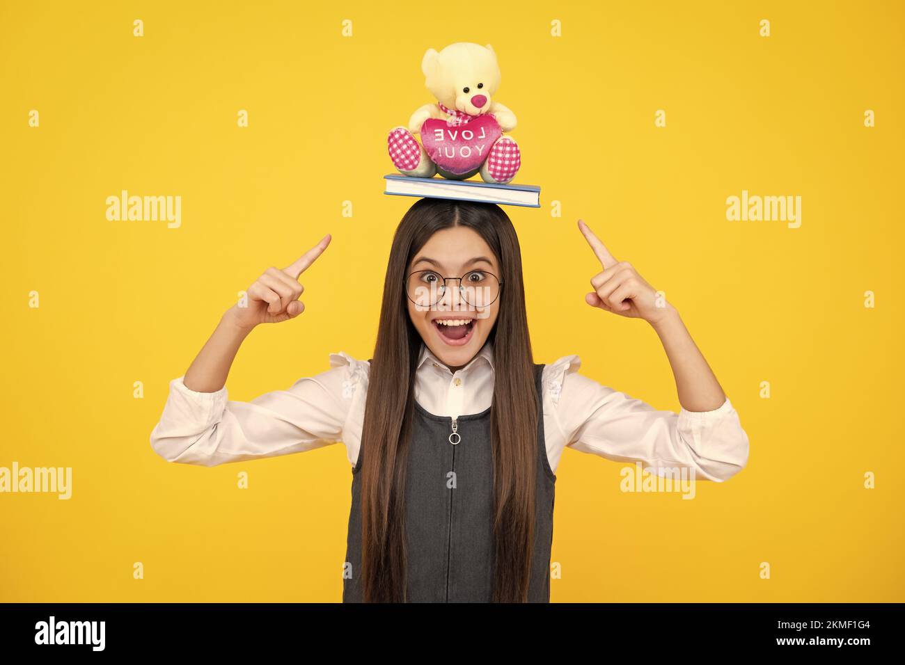 Schoolchild, teenage student girl with toy on isolated studio ...