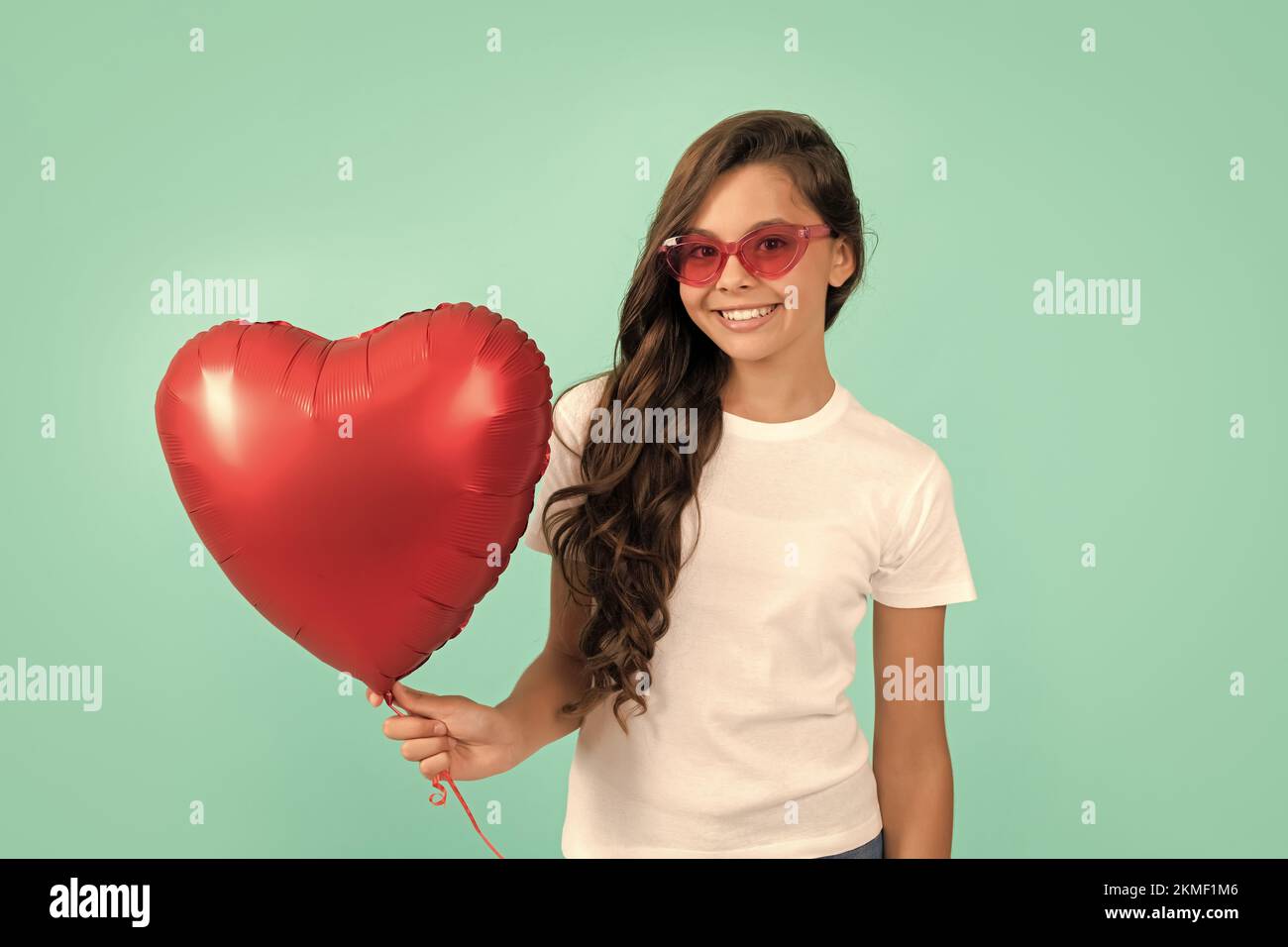 happy child in sunglasses hold red heart party balloon for valentines ...