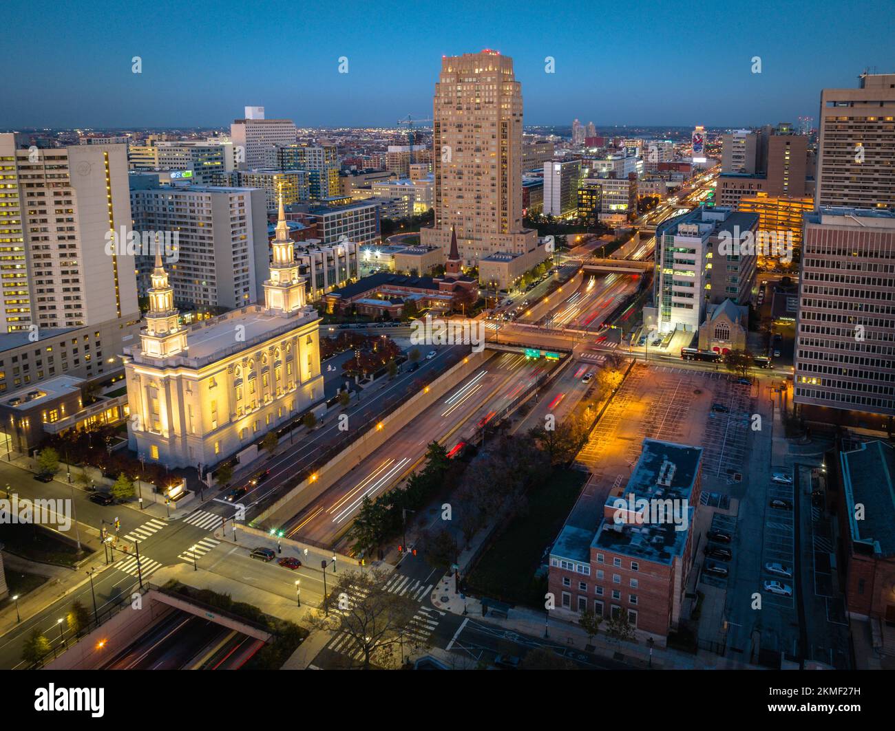 A high-angle drone shot of skyscrapers and a wide highway in ...