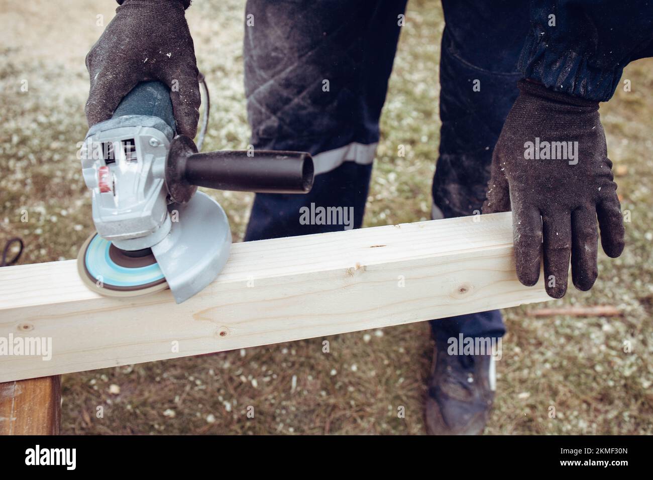 Man using electric grinder to polish wood plank Stock Photo - Alamy