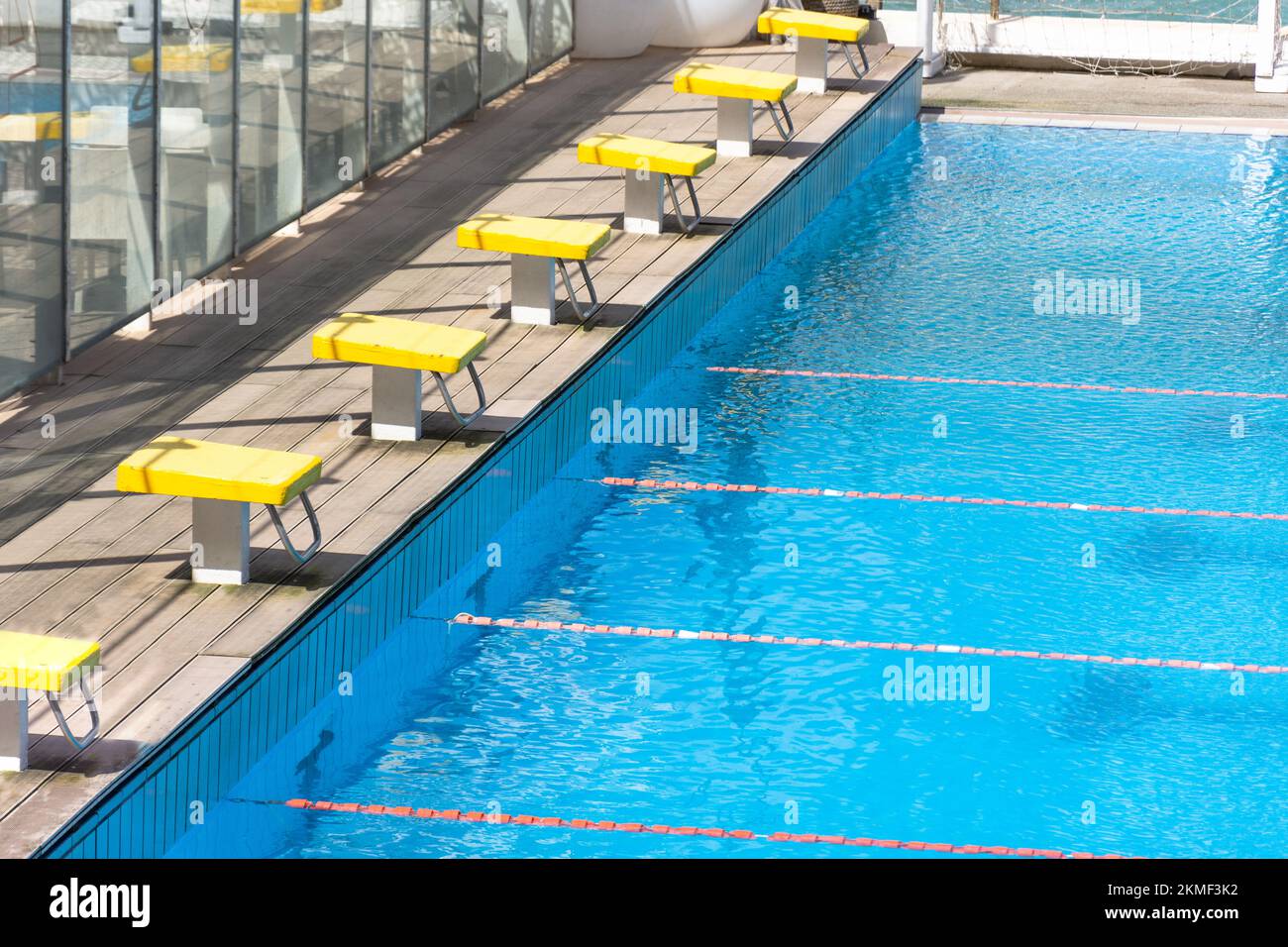Starting blocks, jump platform in row by the swimming pool Stock Photo ...