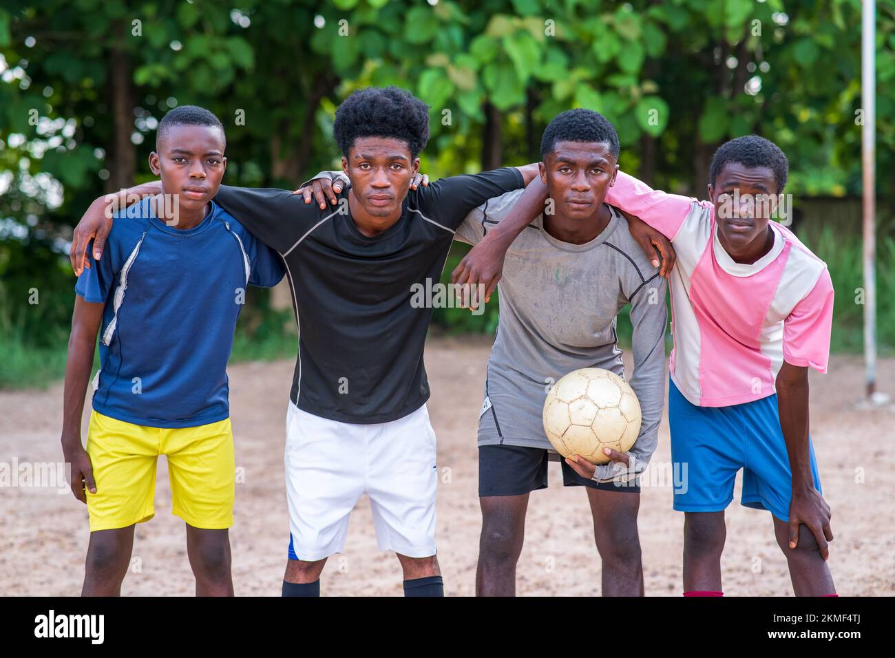 Cool team of African teenagers posing on a soccer field Stock Photo - Alamy