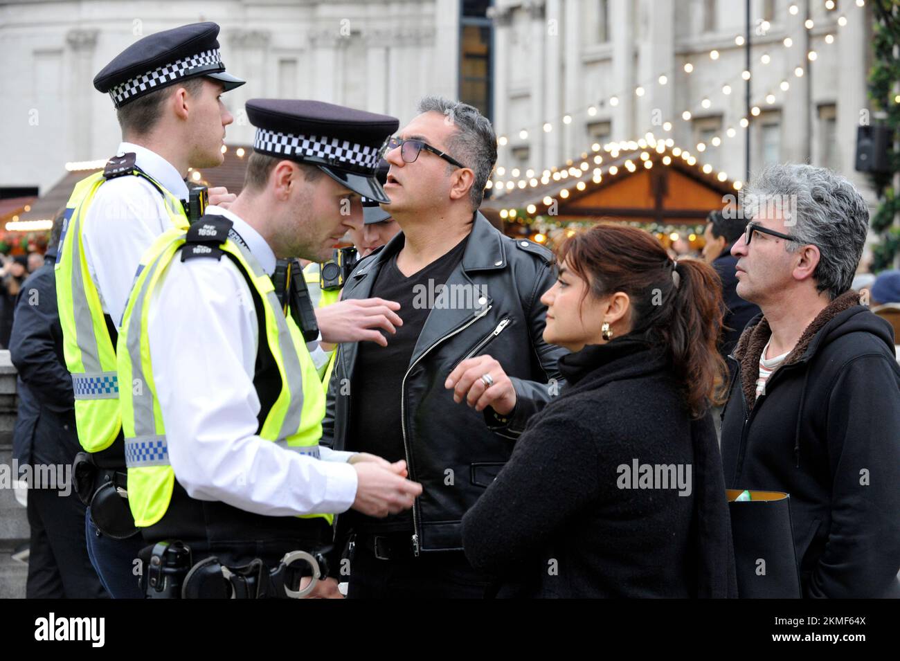 London, UK. 26th Nov, 2022. A woman in black coat with her companion in ...