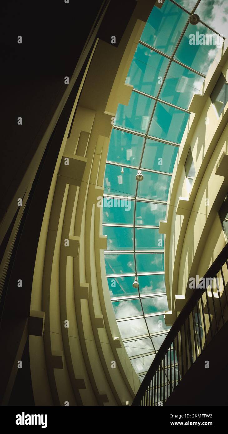 A vertical shot of white walls and an arched glass ceiling over a ...