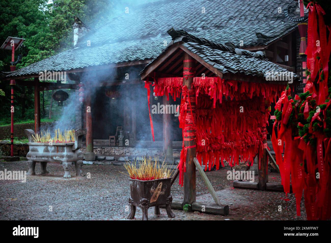 The temple in the village with incense smoke Stock Photo - Alamy