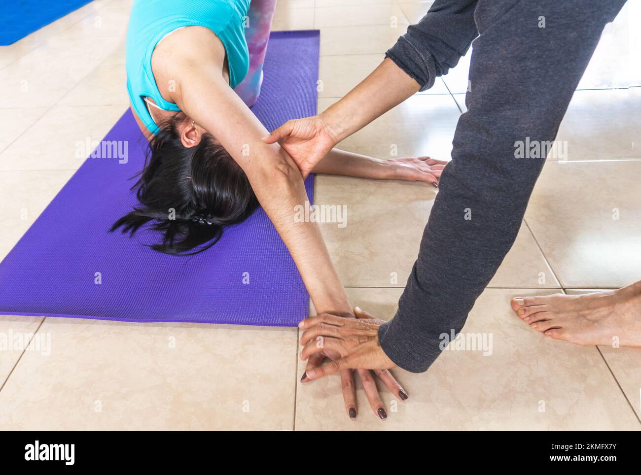 Close-up of the hands of an unrecognizable instructor helping a student ...