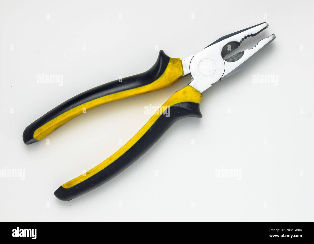 A black and yellow pliers isolated in white background Stock Photo - Alamy