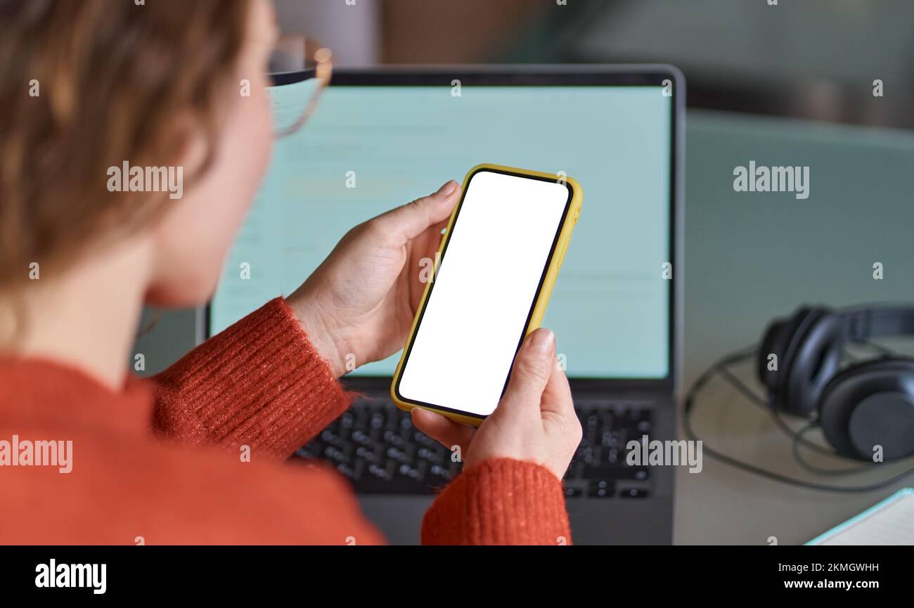 Over shoulder view of woman holding mobile phone with mock up screen ...