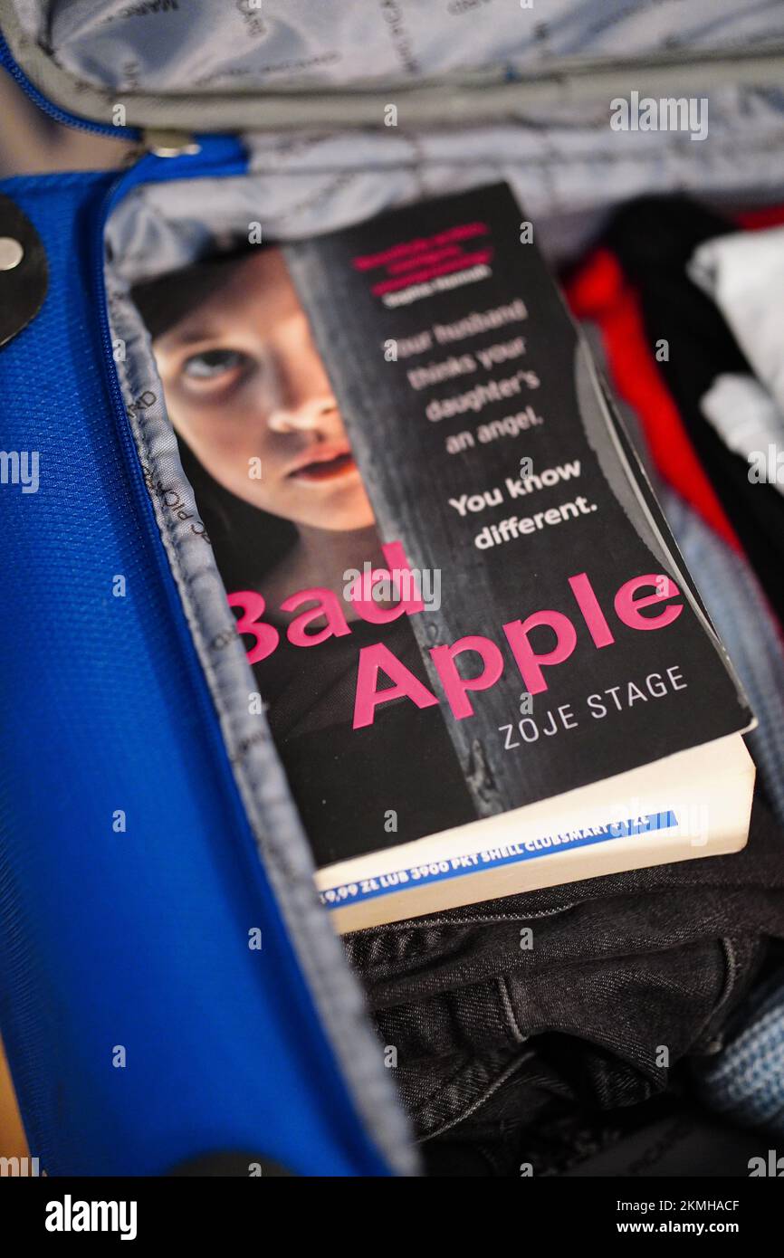 A Zoje Stage Bad Apple novel inside an open travel suitcase Stock Photo ...