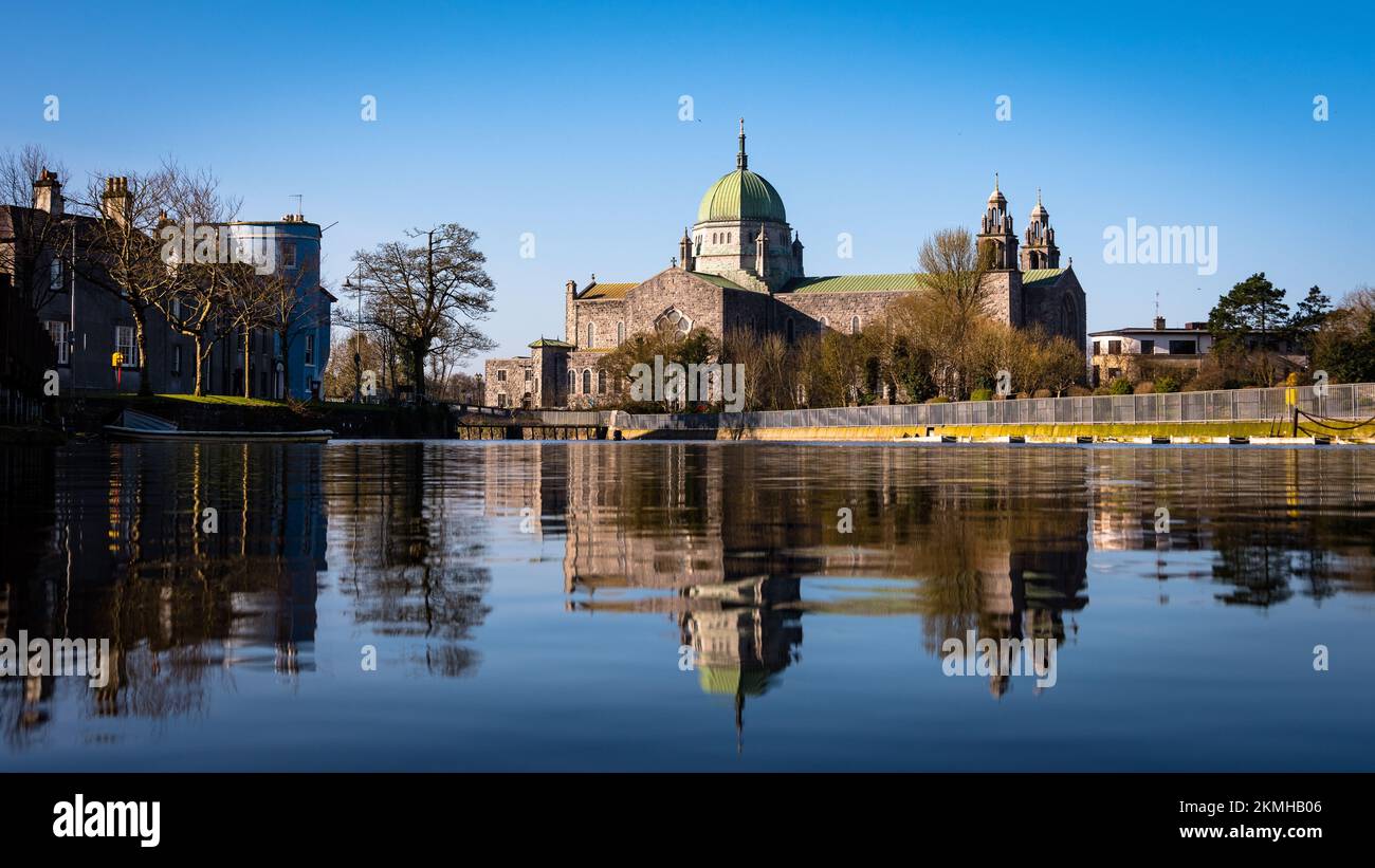 A beautiful view of a reflective lake and Cathedral in Galway, Ireland ...