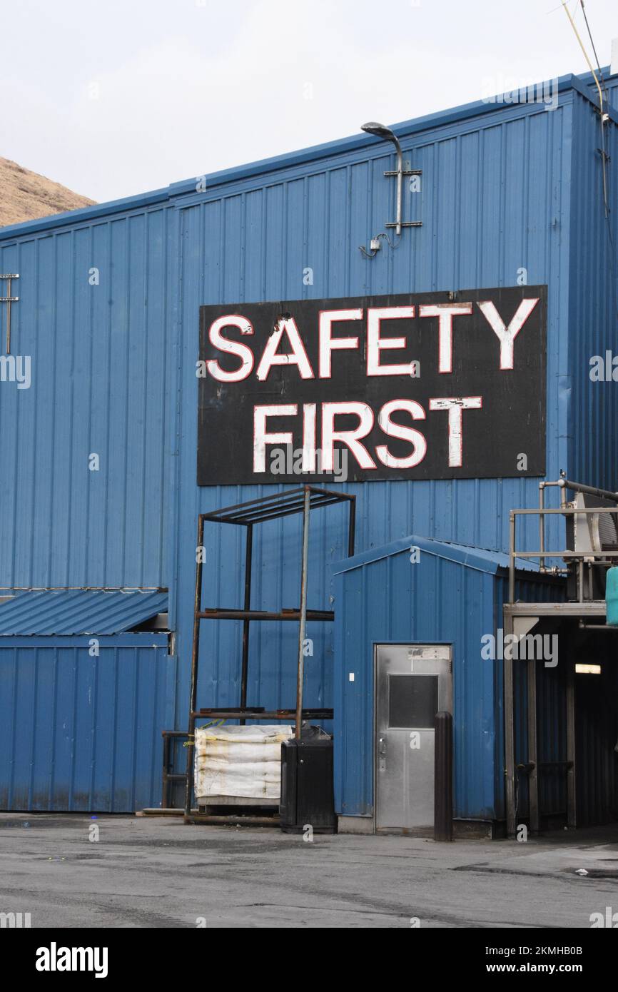 The blue wall of a building with a "Safety First" sign Stock Photo - Alamy