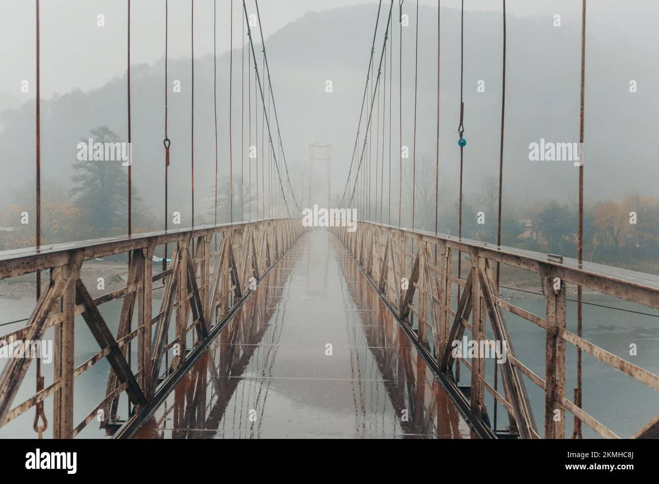 Old iron hanging bridge in rainy weather Stock Photo - Alamy