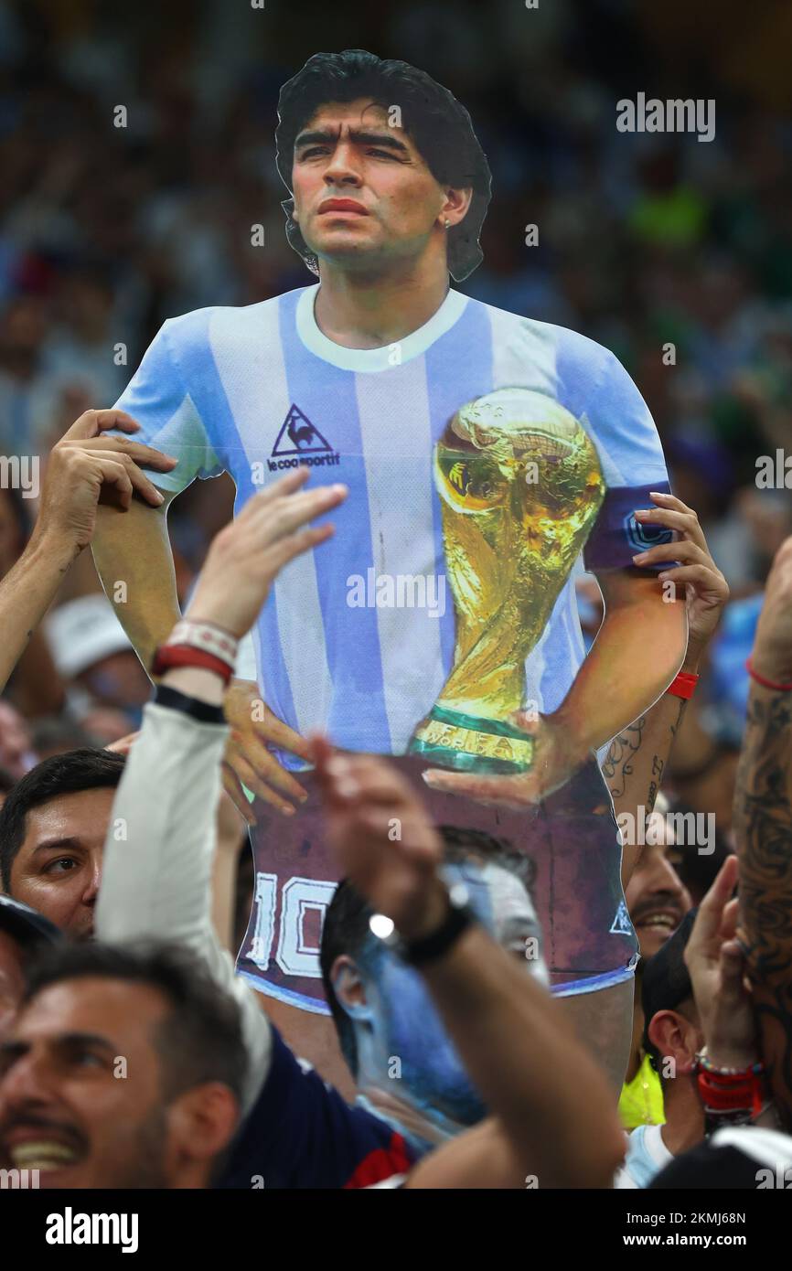 Doha, Qatar. 26th Nov, 2022. A Diego Maradona sign is held up by an ...