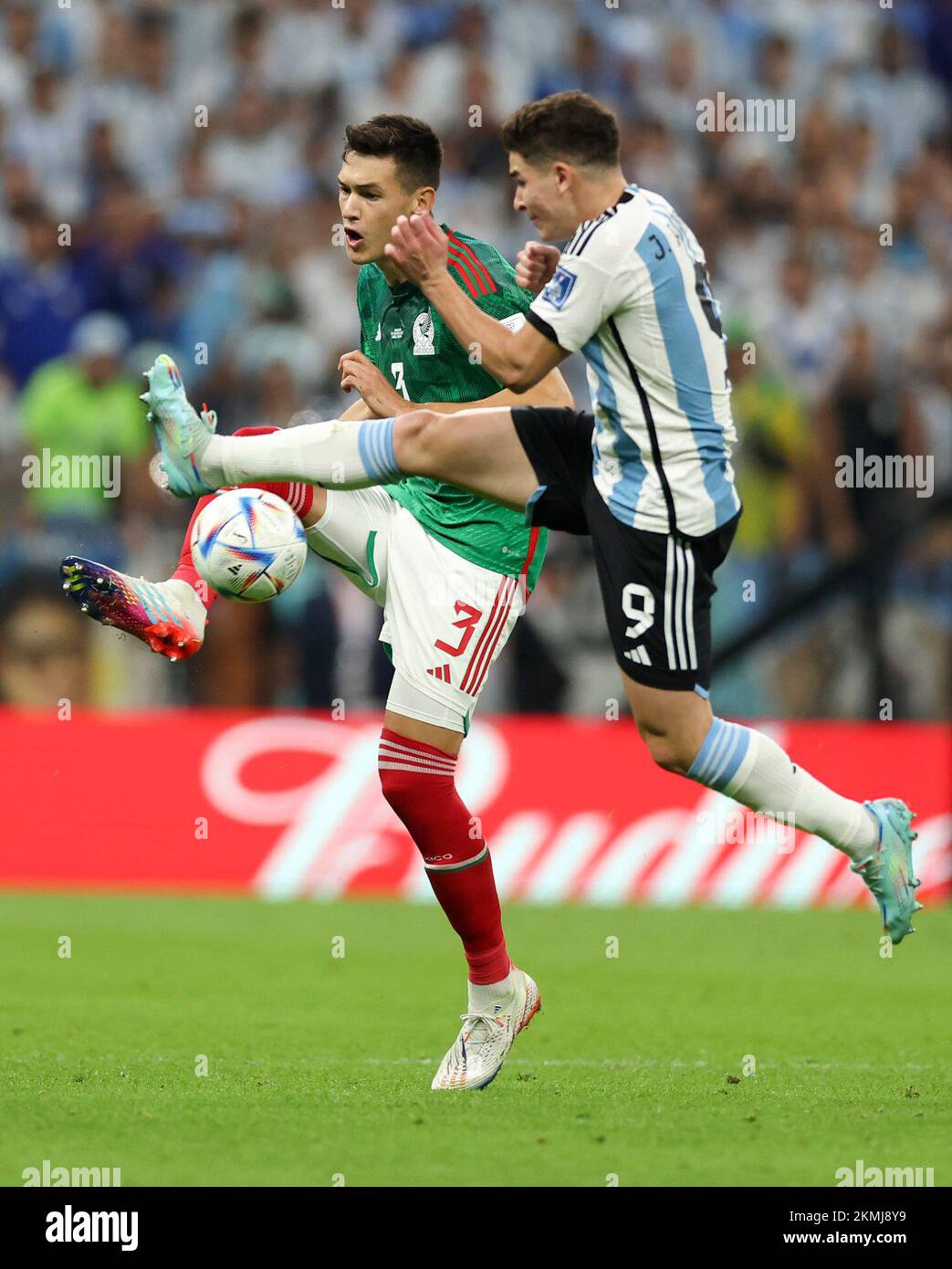 Lusail, Qatar. 26th Nov, 2022. Julian Alvarez (R) of Argentina vies ...