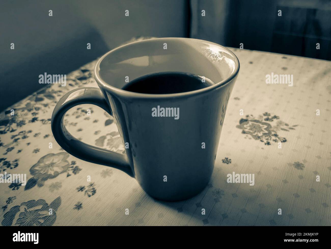 Old black and white picture of Red cup of coffee on grandmas table ...