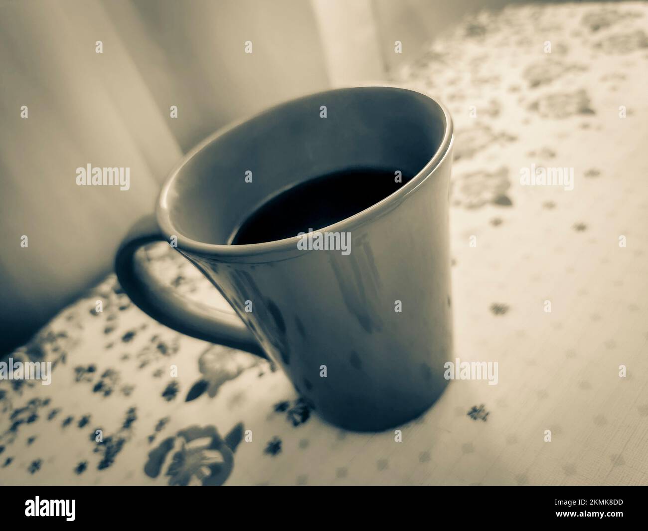 Old black and white picture of Red cup of coffee on grandmas table ...