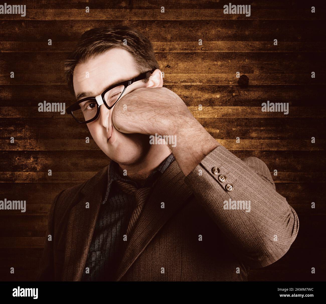 Stressed business man sucker punching self in face when in error ...