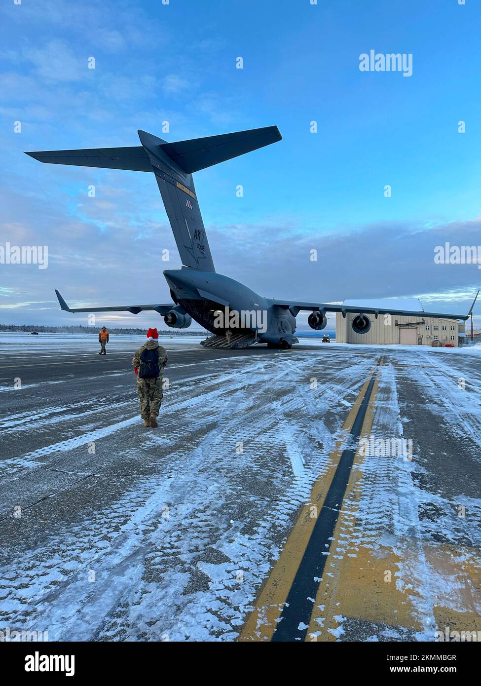 One of Santa’s helper elves prepares to board a 144th Airlift Squadron ...