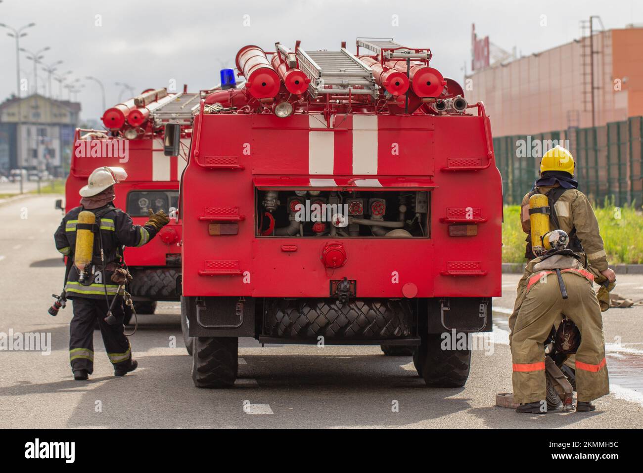 An old fire engine and a team of rescue firefighters conduct ...
