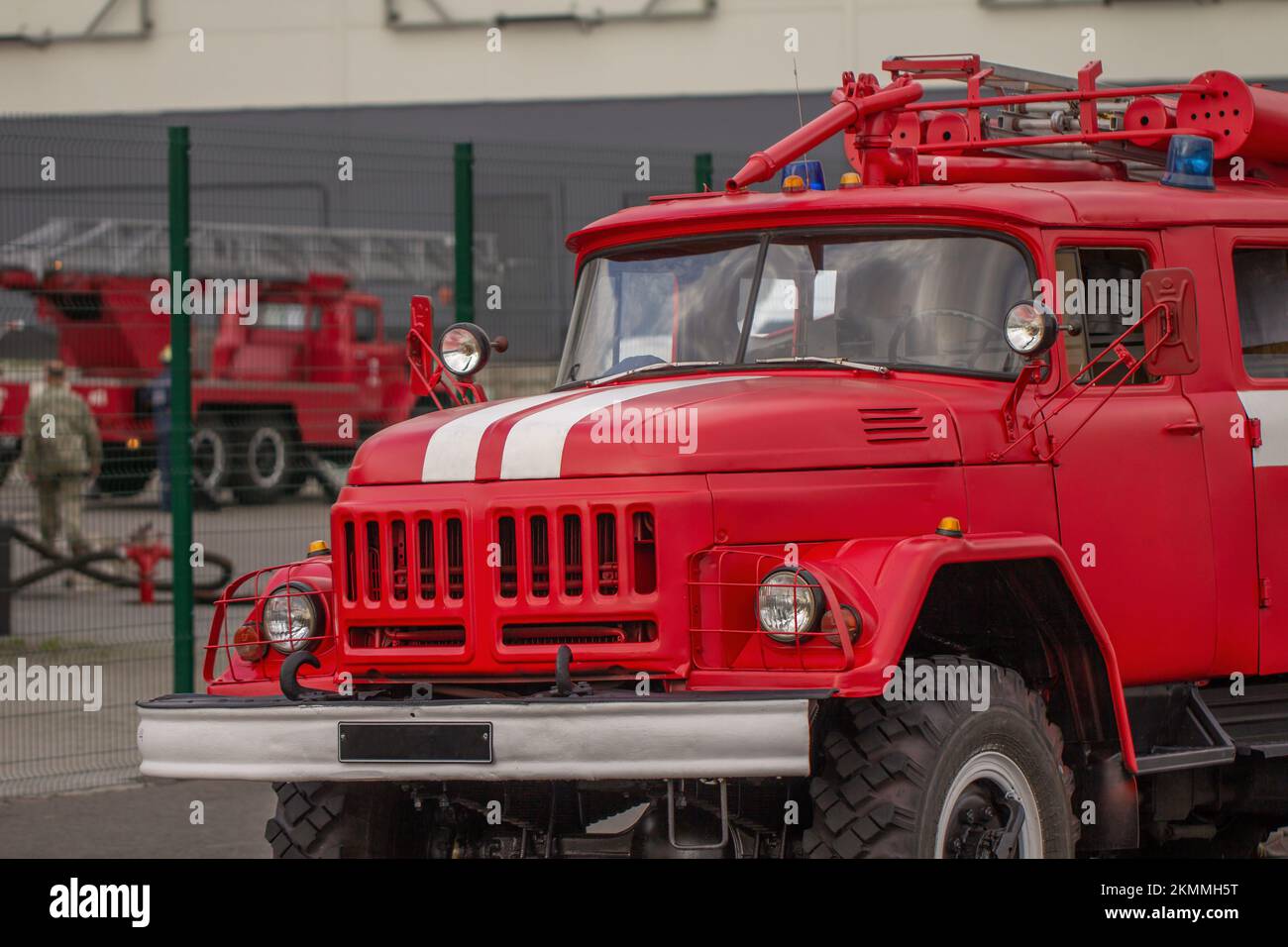 An old fire engine and a team of rescue firefighters conduct ...