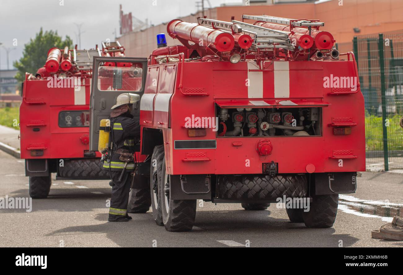 An old fire engine and a team of rescue firefighters conduct ...