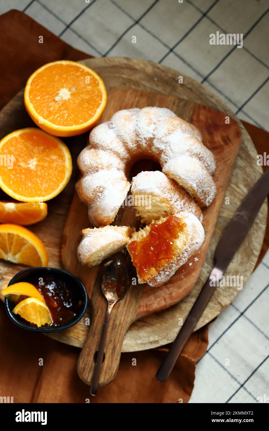 Soft and tender orange cake in powdered sugar Stock Photo - Alamy