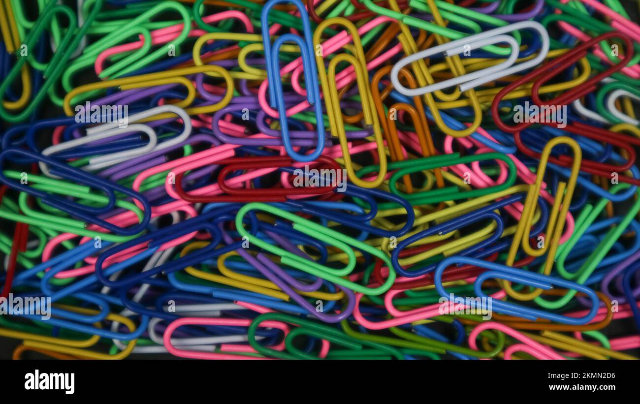 Colorful paper clips isolated on black background Stock Photo - Alamy