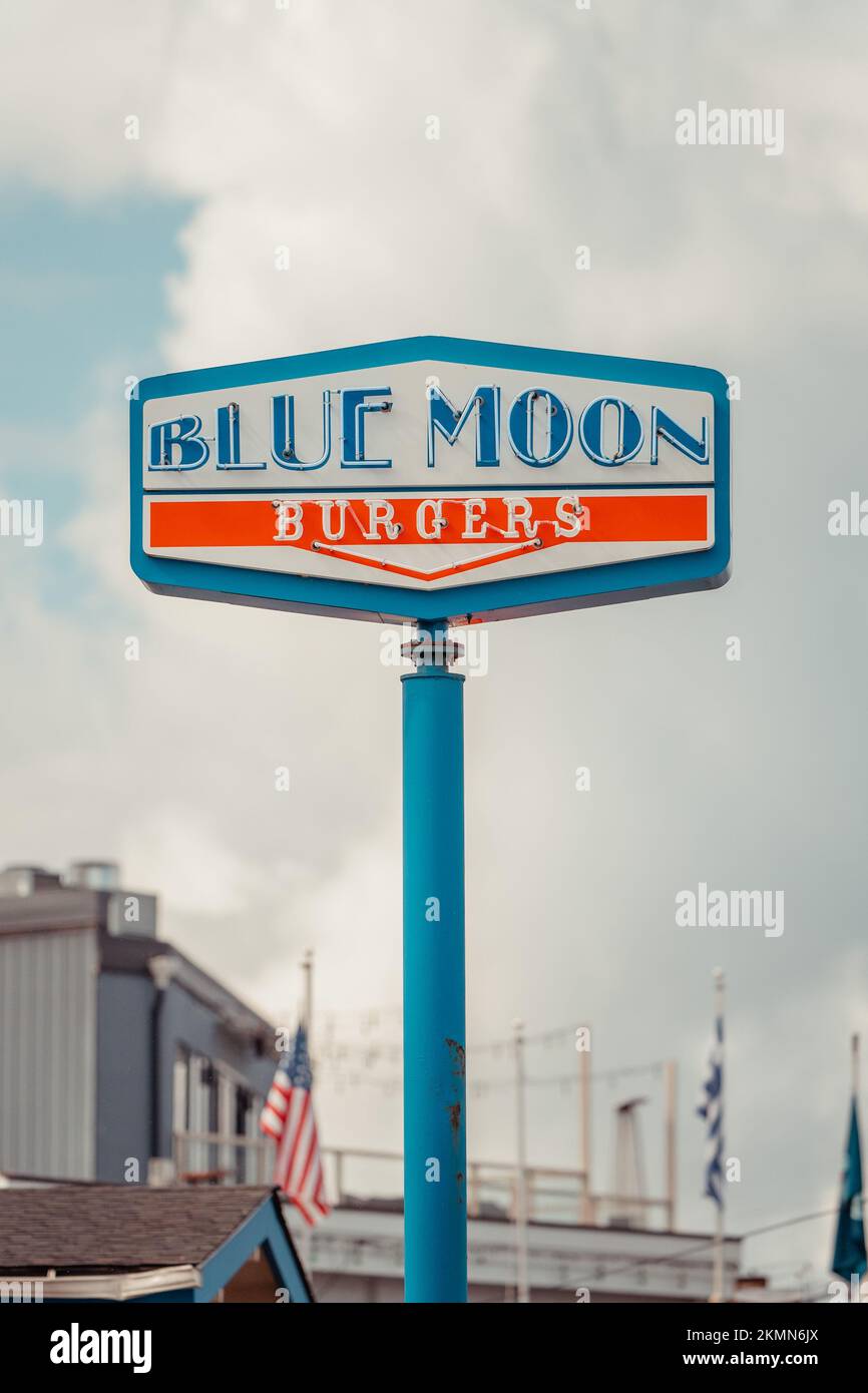The banner of Blue Moon Burgers with blue and red brand logo near Alki ...