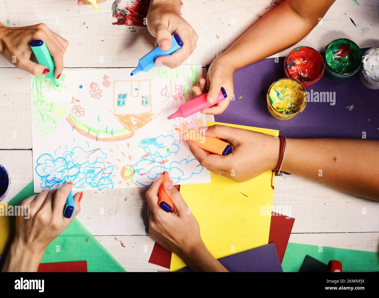 Hands hold colorful markers and draw kids illustration, top view Stock ...