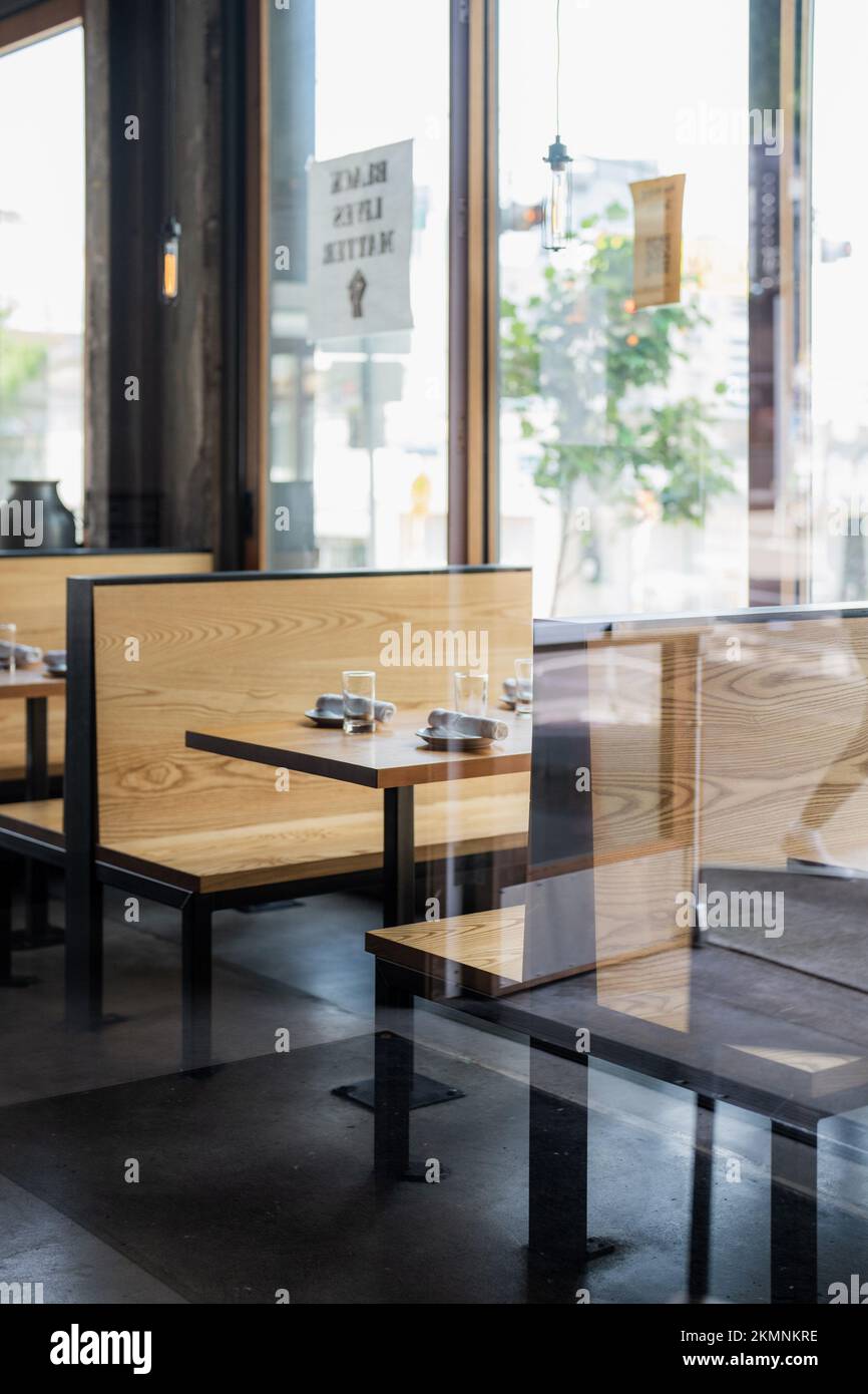 Interior view of a business coffee shop with wooden bench chairs in ...