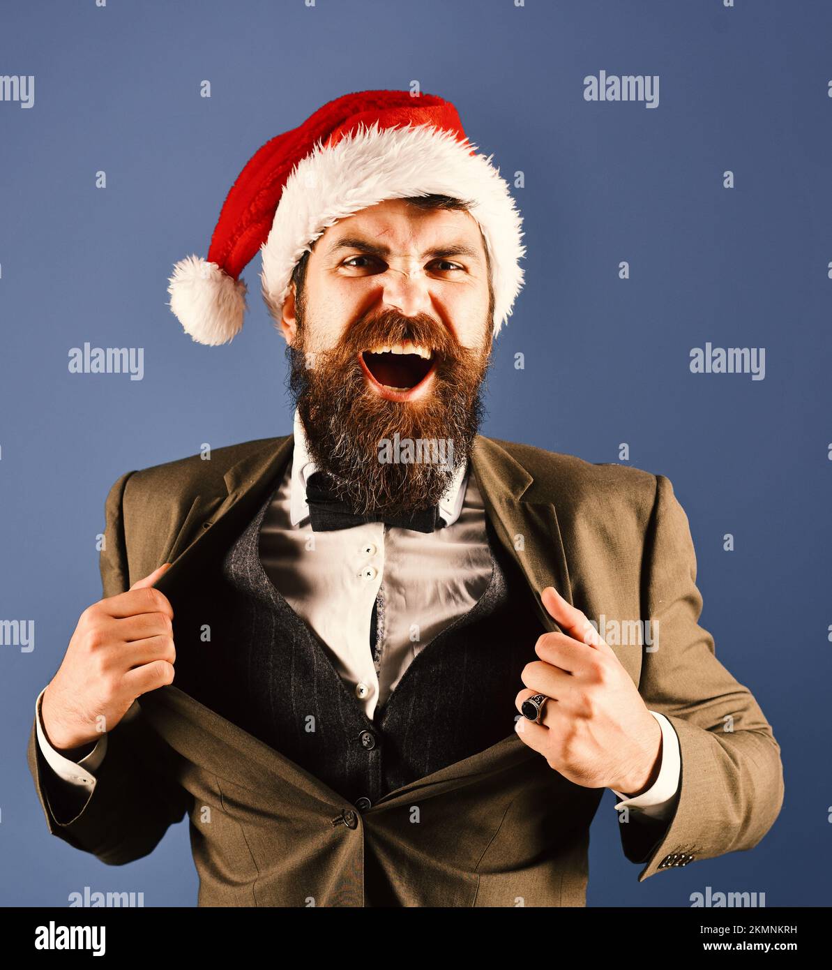 Man with beard in smart suit and Santa hat Stock Photo - Alamy