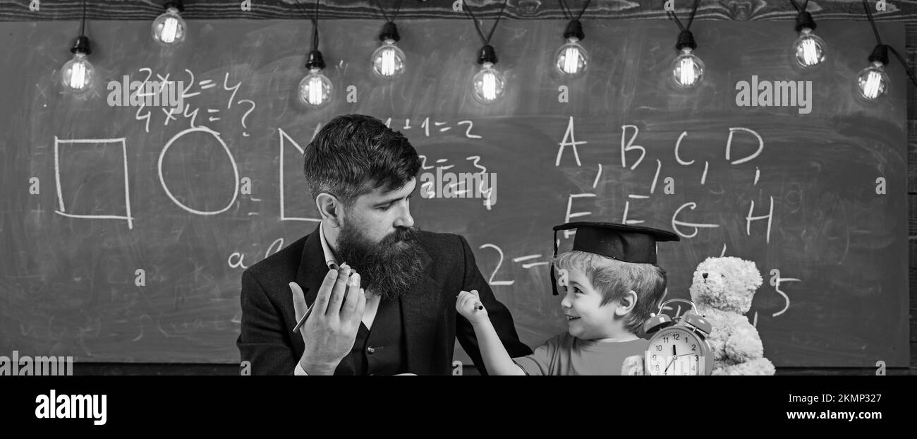 Father teaches son mathematics. Teacher in formal wear and pupil in ...