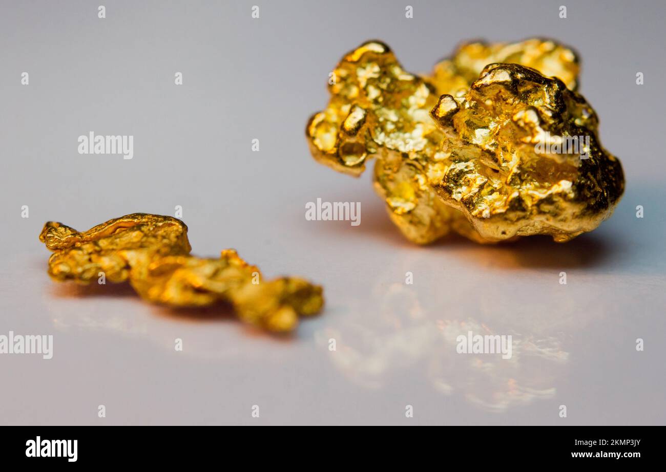 Close-up of a gold-nugget on a white background Stock Photo - Alamy